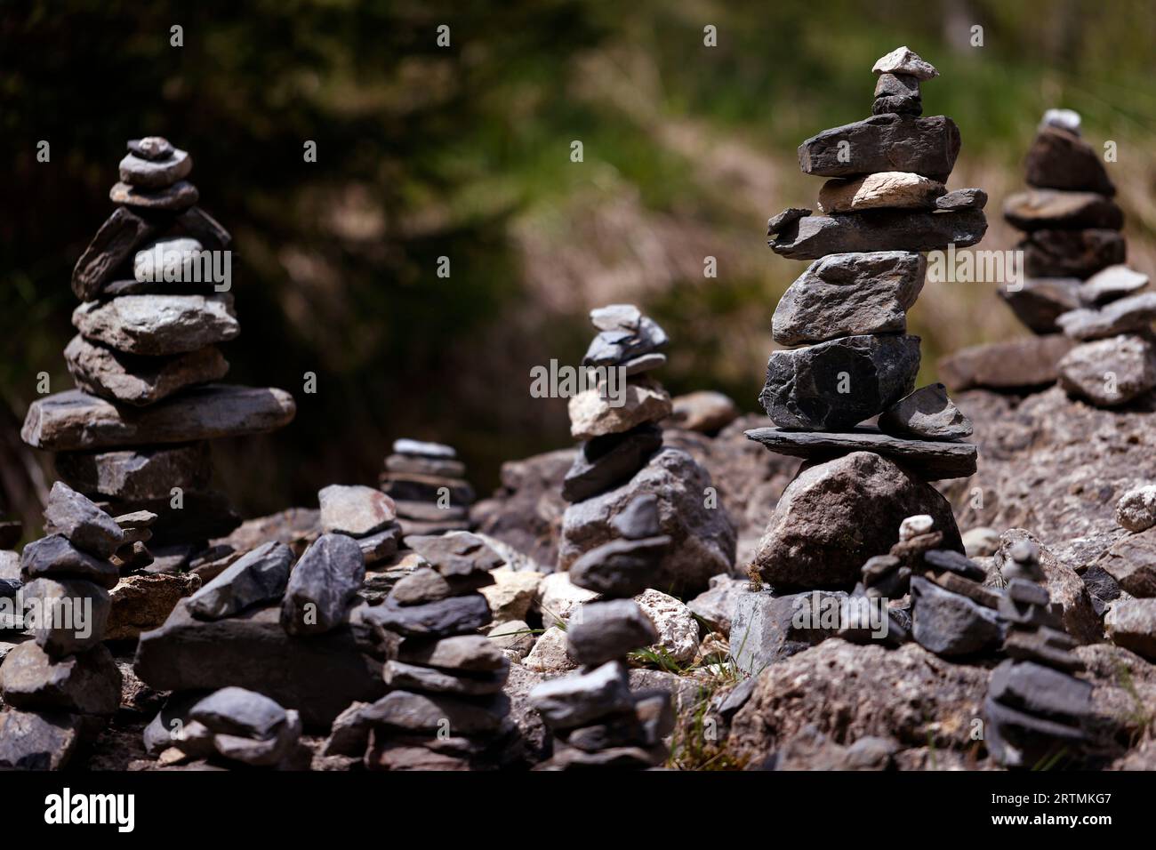 Close up on cairn, stoned pyramid, tourist memory sign on mountain path ...