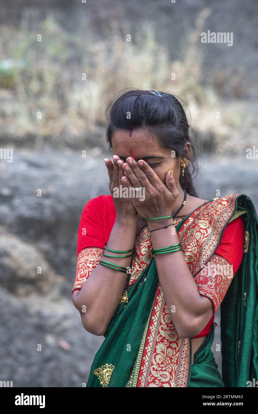 Praying woman wearing a sari in Daulatabad fort, Maharashtra, India ...
