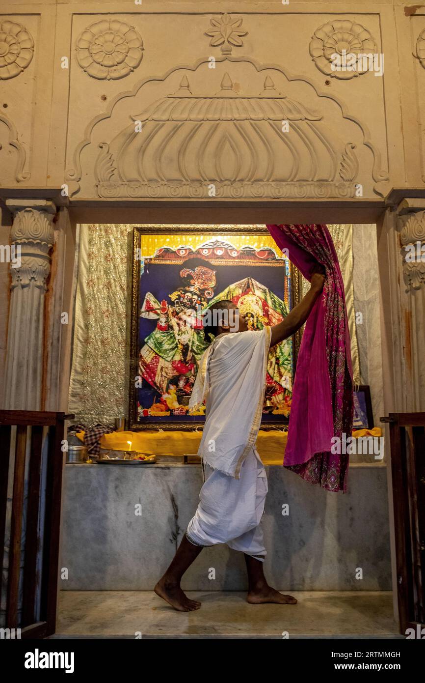 Priest pulling the curtain in a temple at Goverdan ecovillage ...