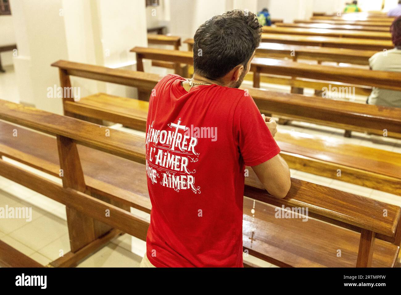 Young man praying in Notre Dame de la Delivrance catholic basilica ...