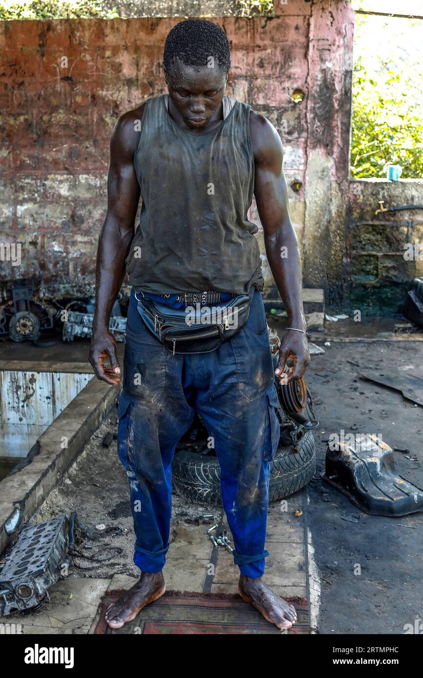 Muslim mechanic praying in the garage where he works in Fatick ...