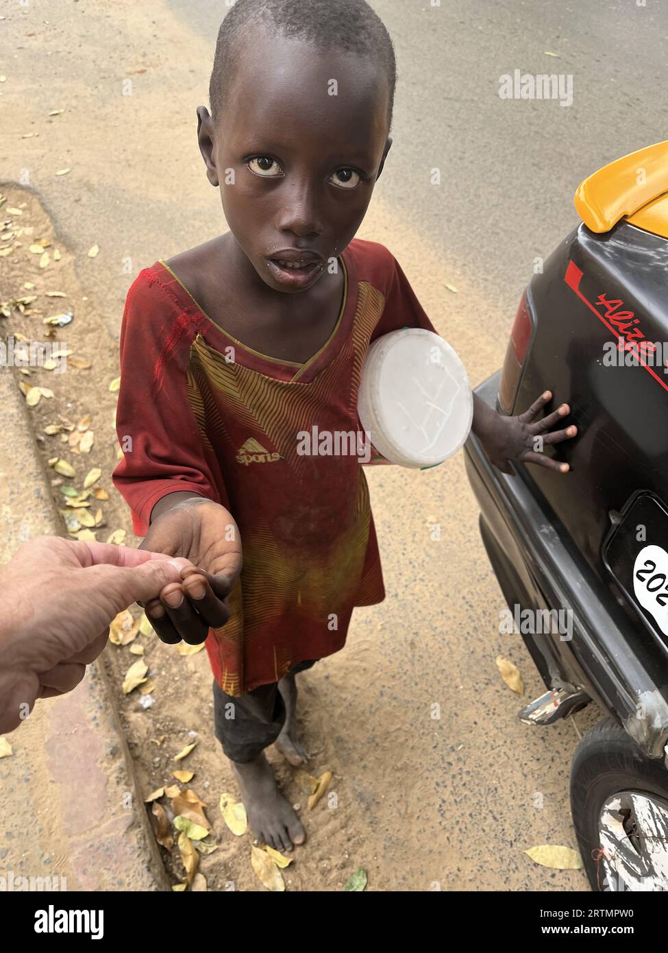 Boy receiving alms hi-res stock photography and images - Alamy