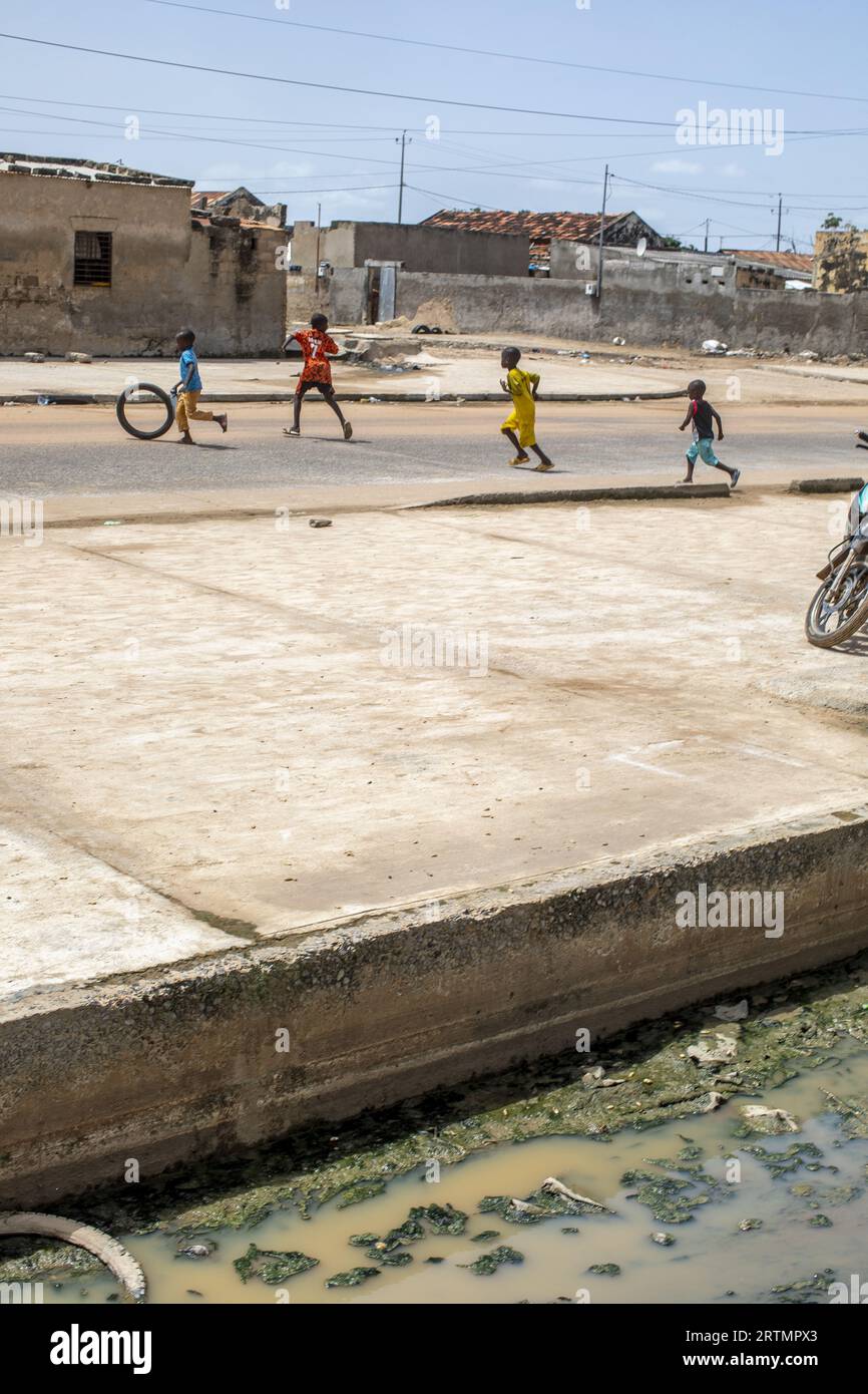 Open sewer and playing children in Kaolack, Senegal Stock Photo - Alamy