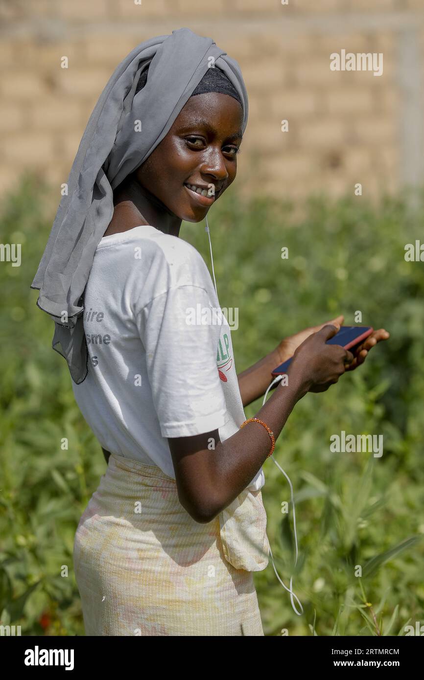 Smiling young Senegalese girl with cell phone in Touba, Senegal Stock ...