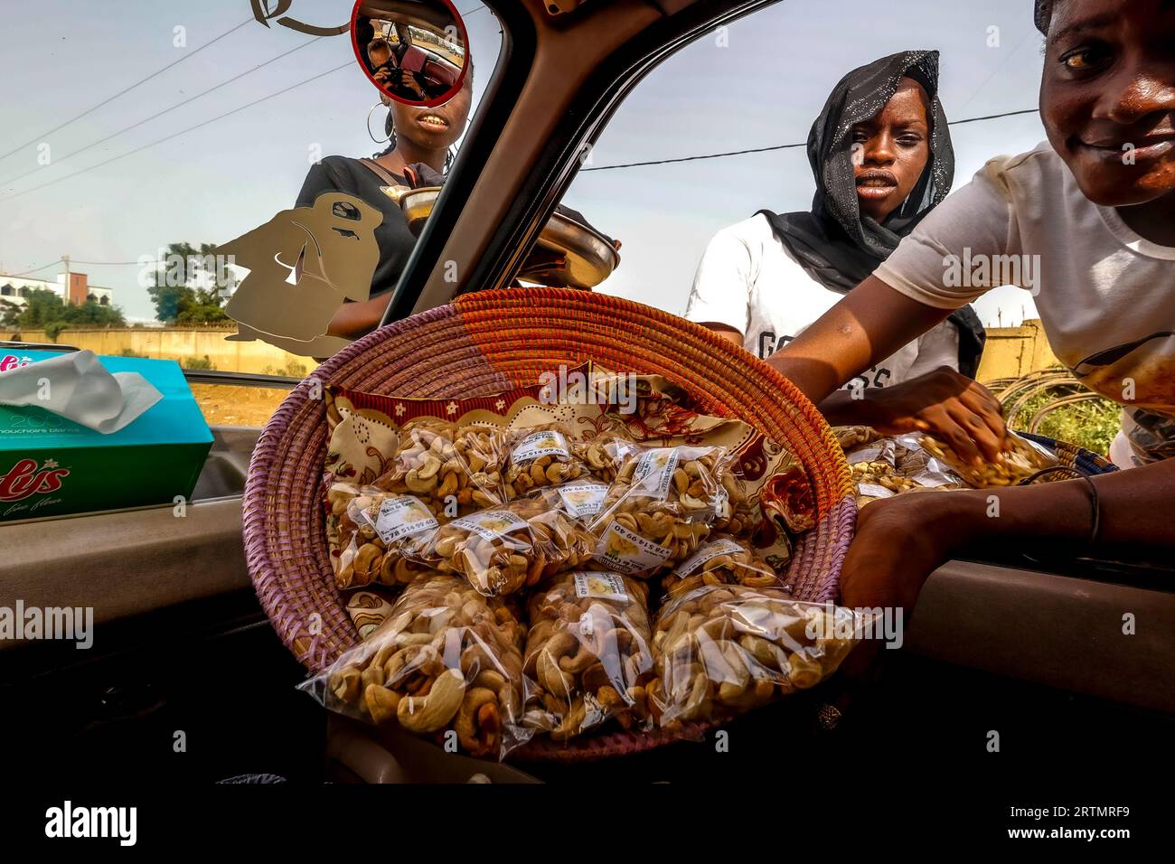 Girls selling cashew nuts in Thies, Senegal Stock Photo - Alamy