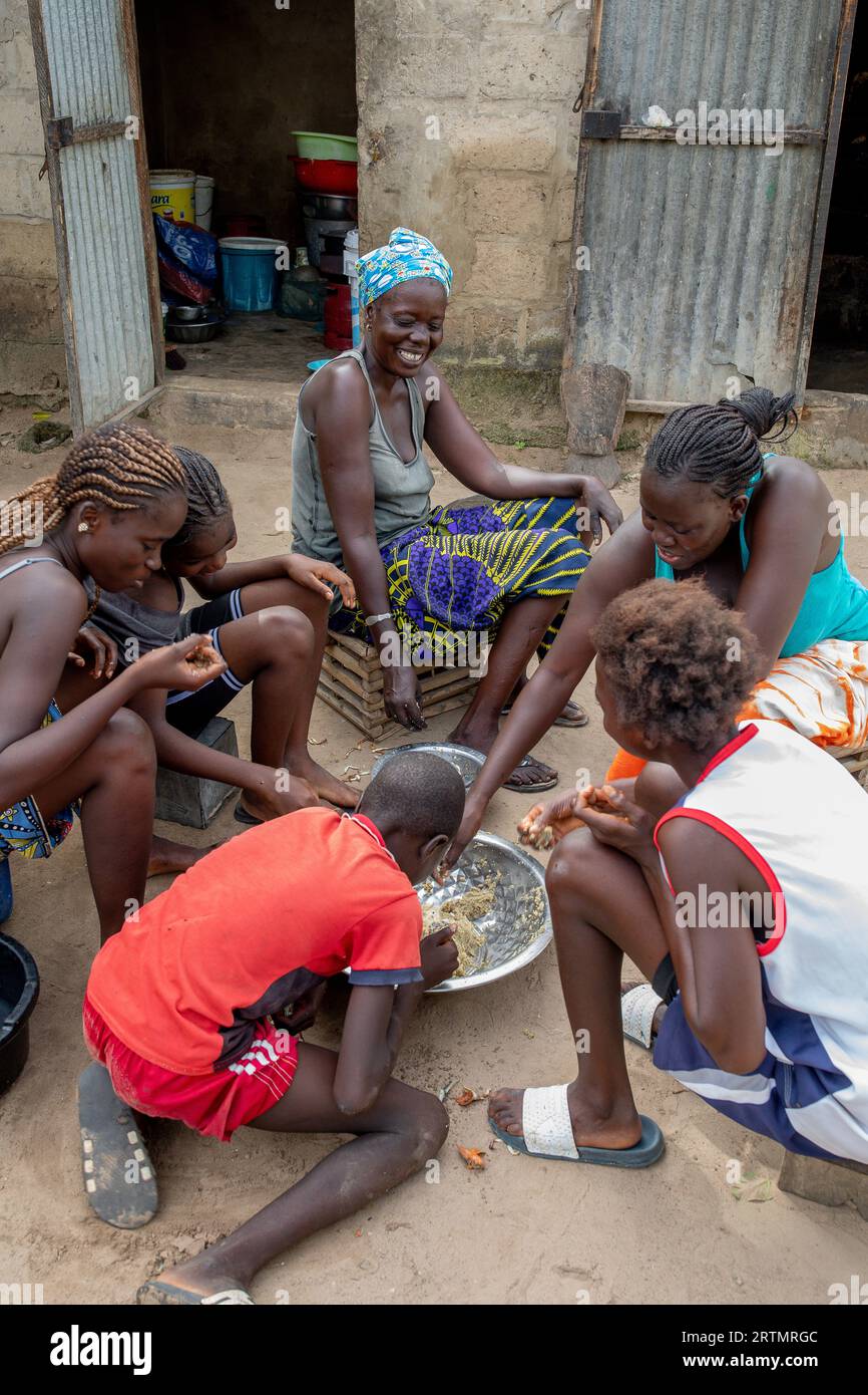 Family sharing a meal in a village near Fatick, Senegal Stock Photo - Alamy