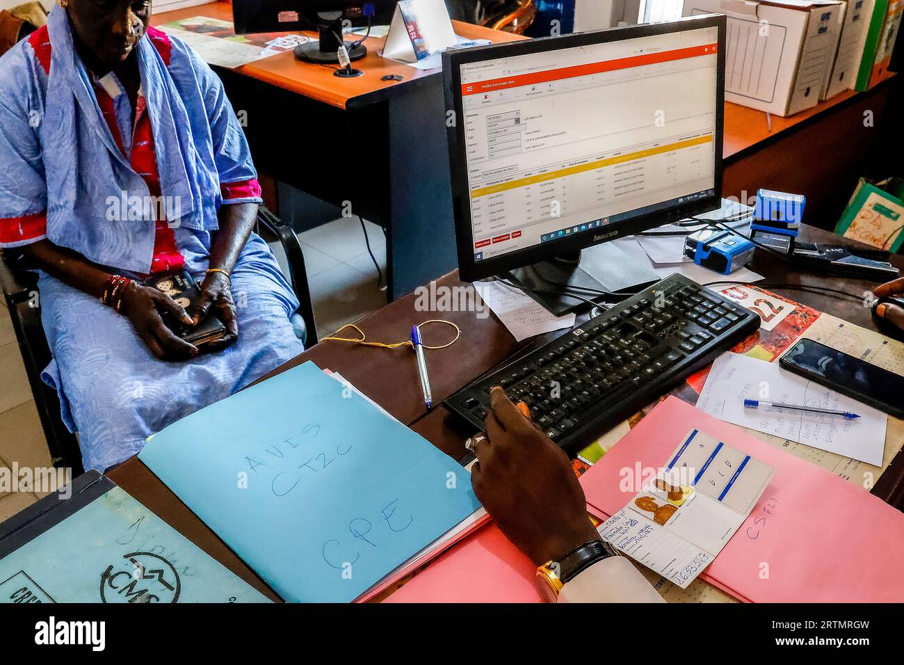 Client in a microfinance agency office in Fatick, Senegal Stock Photo ...