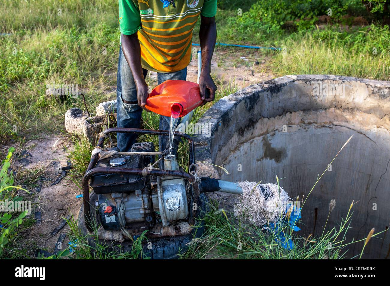 Farmer using a water pump in his field near Fatick, Senegal Stock Photo ...
