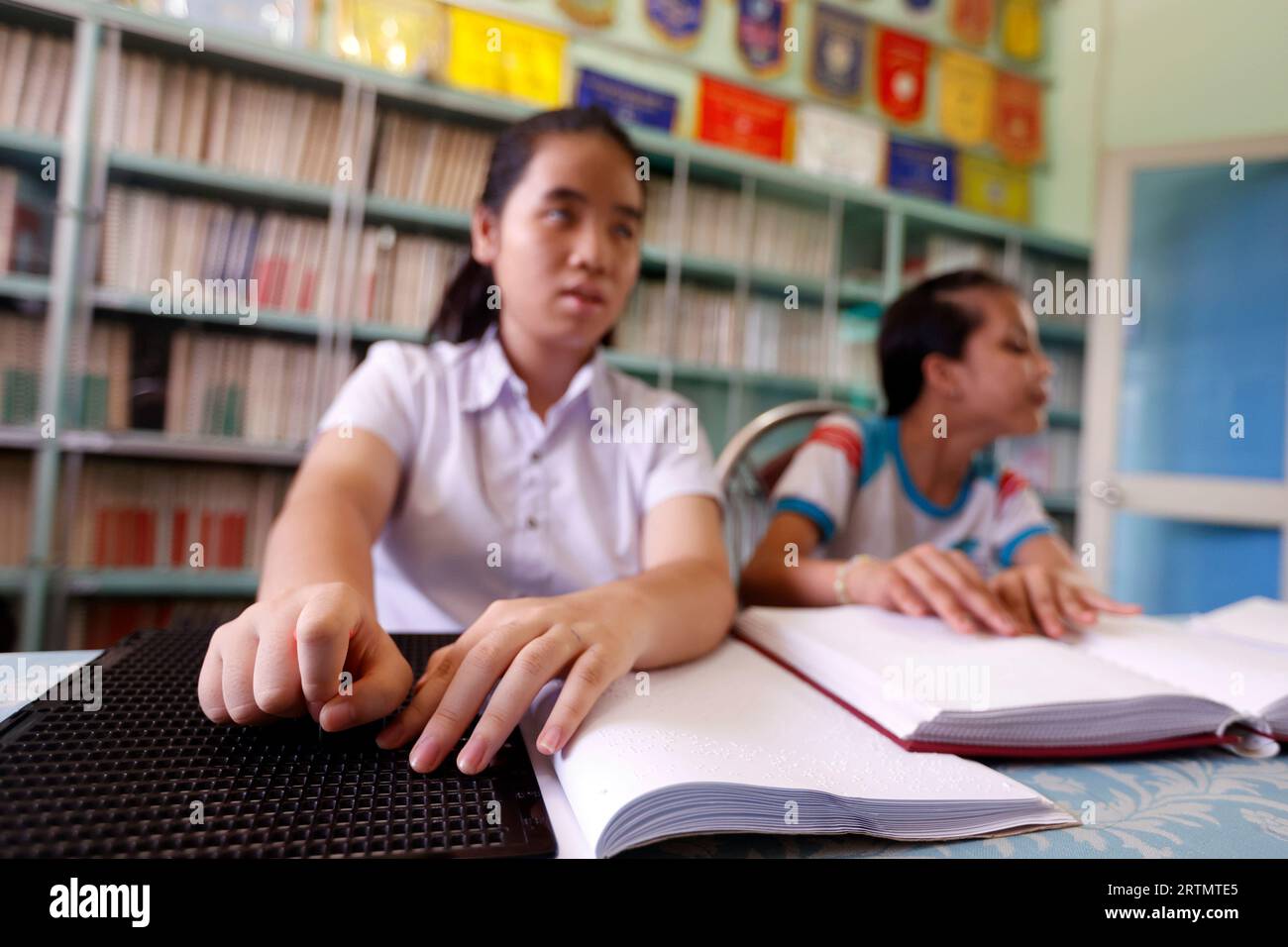 Center for blind children. Blind girls reading braille book Ho Chi Minh ...