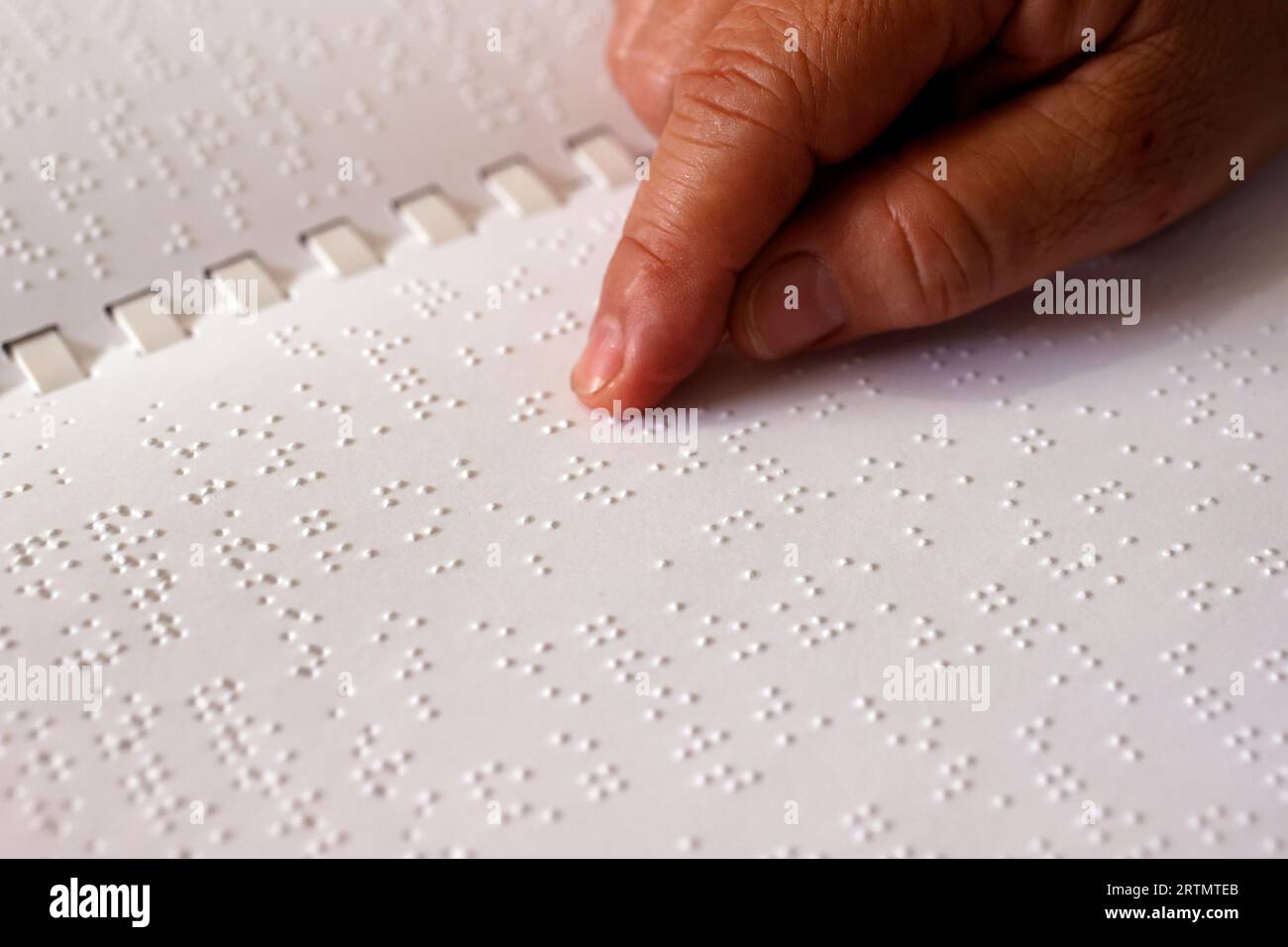 Center for blind children. Blind girl reading braille book Close up on ...