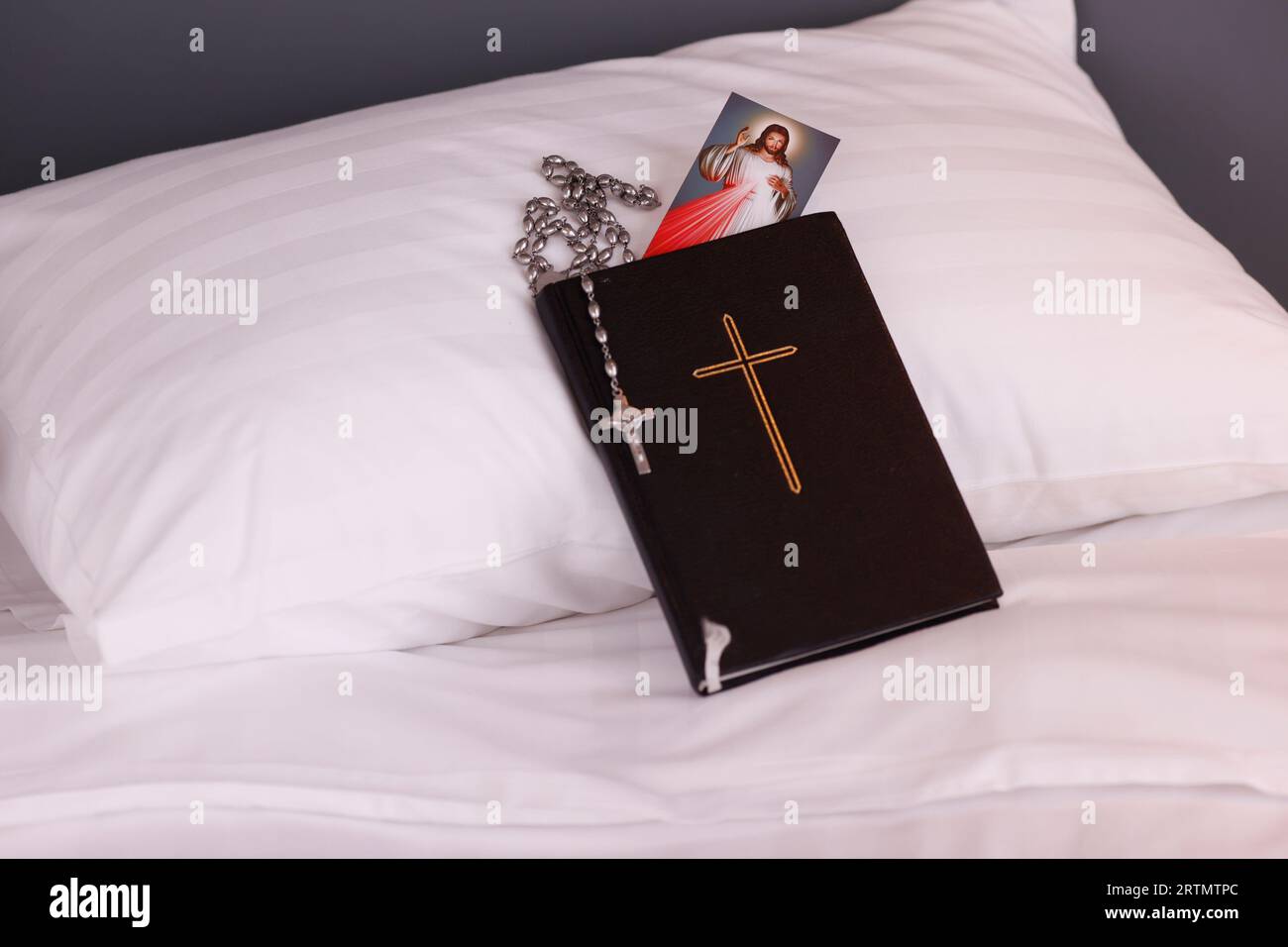 Bible, rosary and picture of Jesus on a bed. Religion at home Stock ...