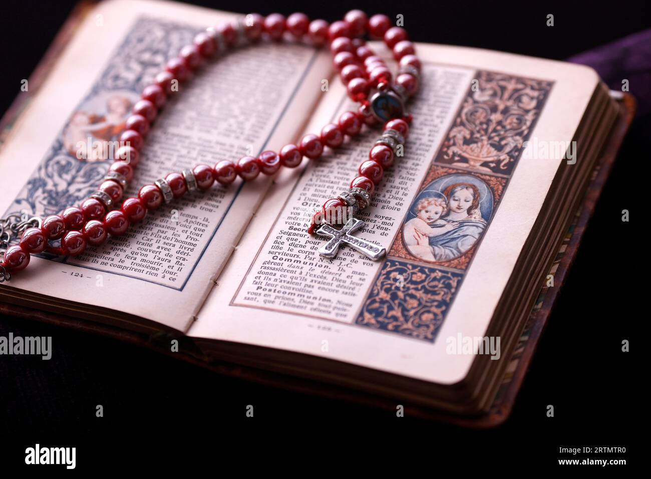 Old Roman Misel and catholic rosary beads. Religious symbol Stock Photo ...