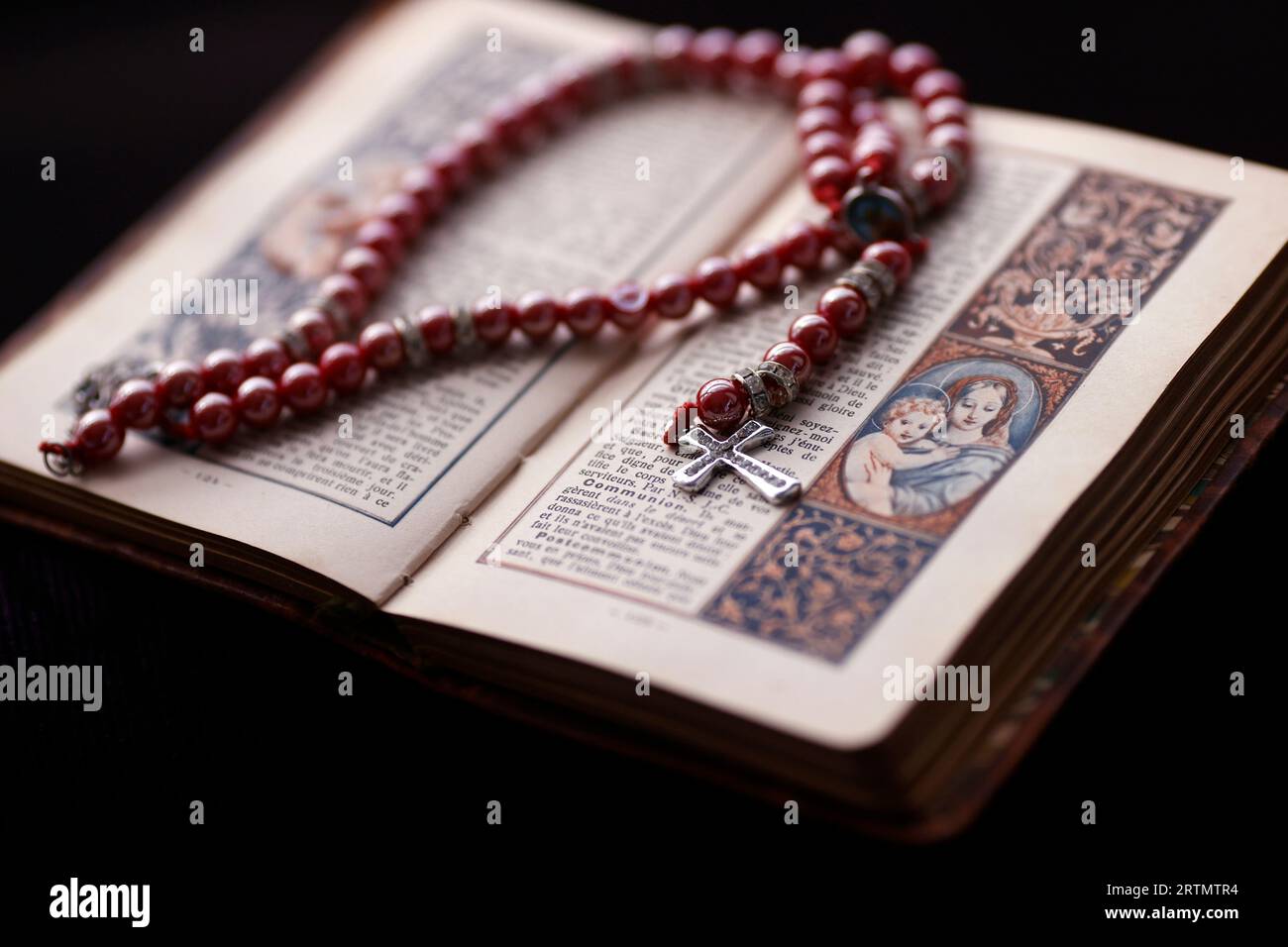 Old Roman Misel and catholic rosary beads. Religious symbol Stock Photo ...