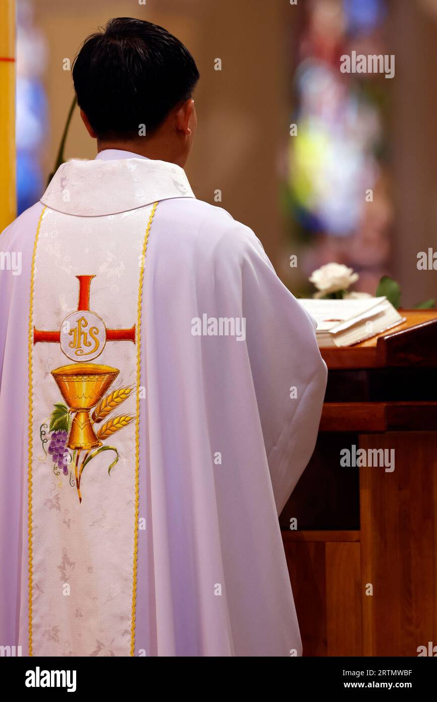 Saint Nicholas Cathedral Dalat. Sunday mass. Back view of Priest with ...