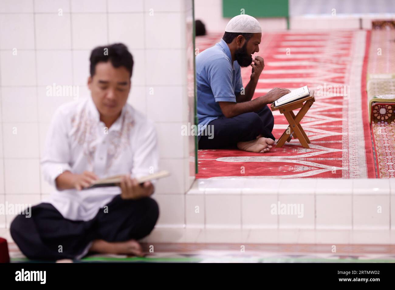 Muslim man reading a Quran Stock Photo - Alamy