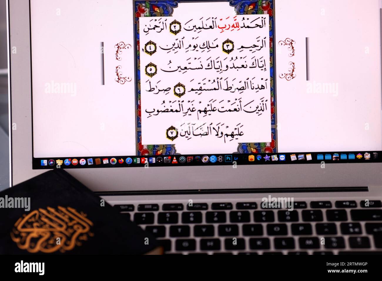Digital Quran on laptop and traditional paper Holy Quran. Paper vs ...