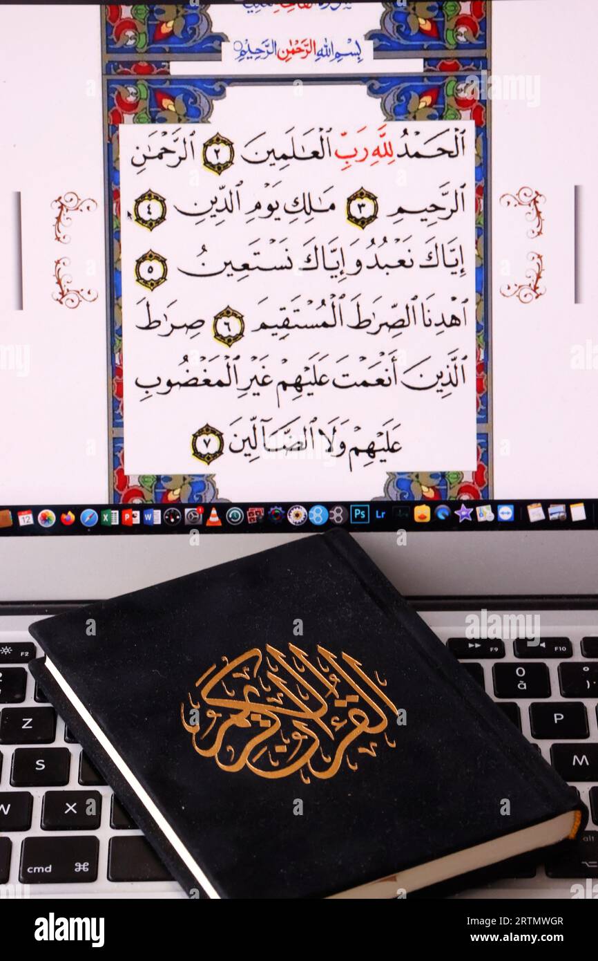 Digital Quran on laptop and traditional paper Holy Quran. Paper vs ...
