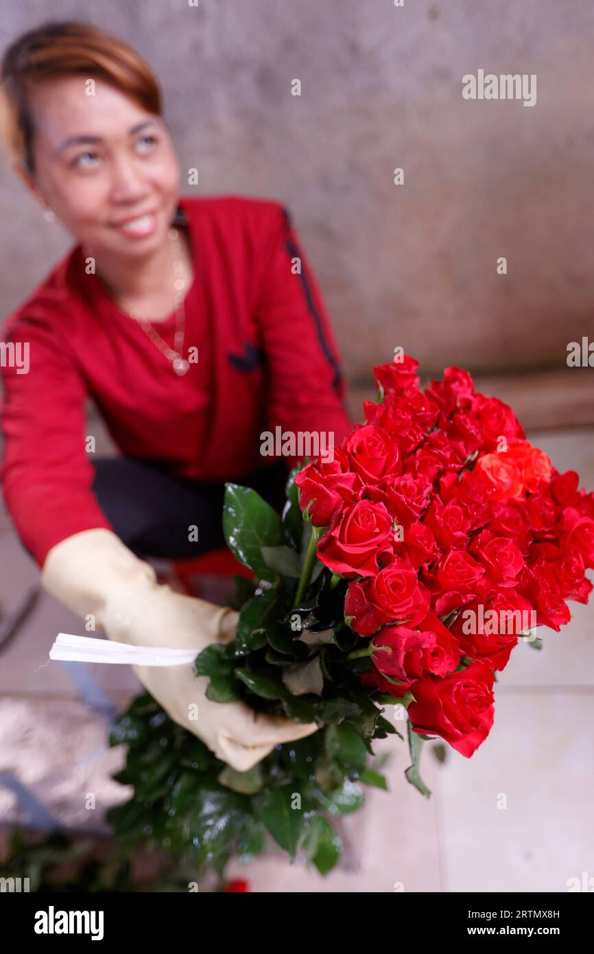 Flower factory. Production of roses. Woman at work. Horticulture. Dalat ...