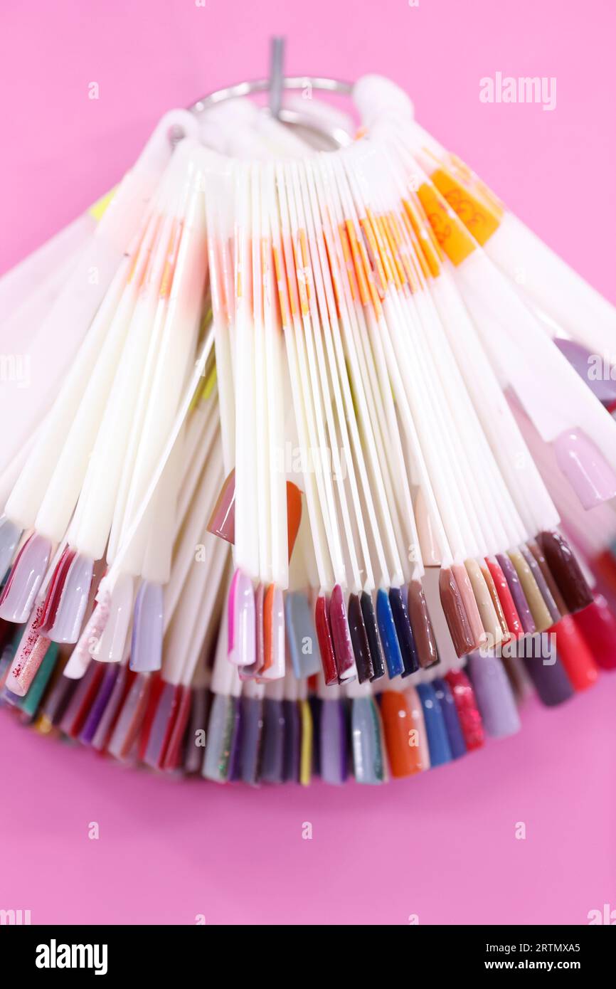 Artificial acrylic nails painted on display in nail salon. Manucure ...