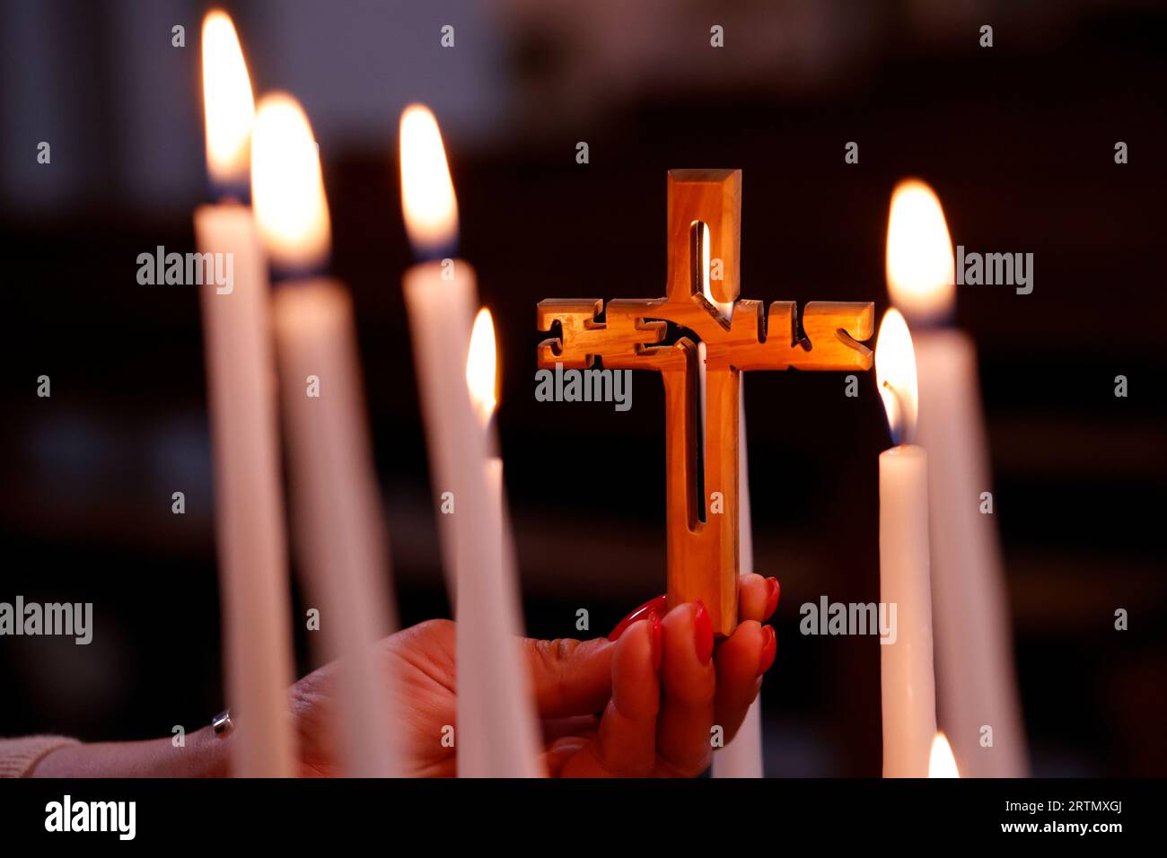Catholic woman praying with candels in a church. Woman praying Jesus ...