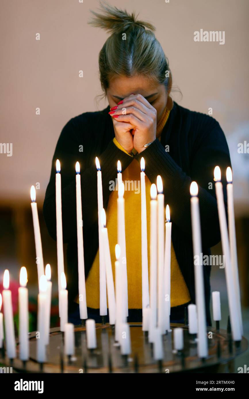 Woman praying in front church hi-res stock photography and images - Alamy