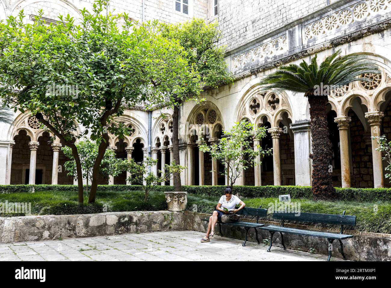 Woman reading in the cloister of the Dominican monastery, Dubrovnik ...
