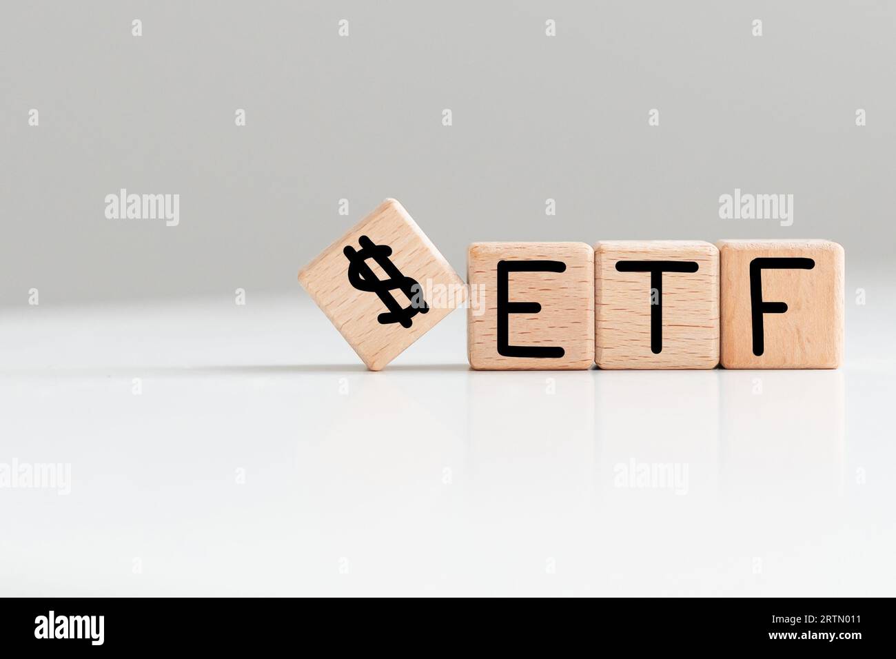 ETF word written on wood block on chart background Stock Photo - Alamy