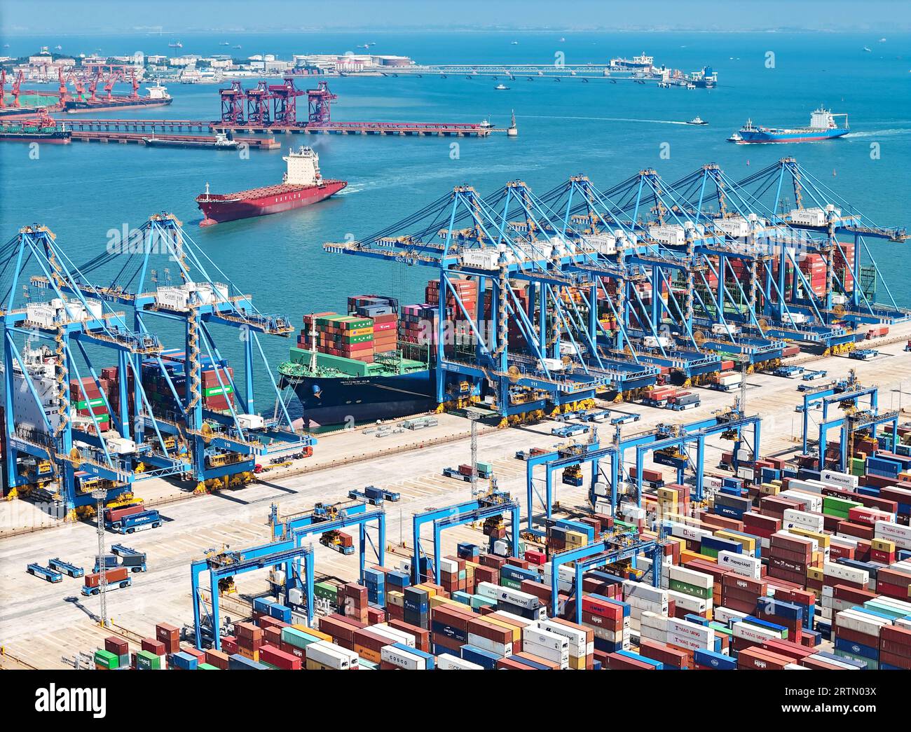 Cargo ships enter and leave the port at the Qingdao section of the ...