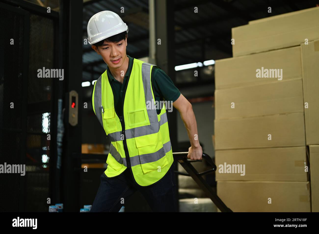 Warehouse pulling pallet truck boxes hi-res stock photography and ...