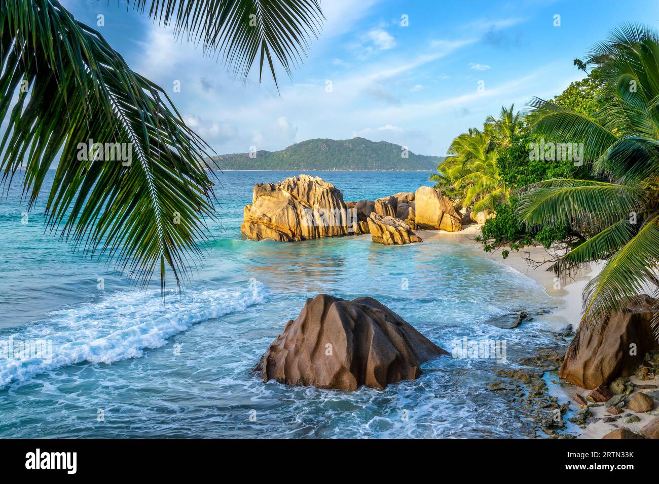 Granite rocks and palm trees on the scenic tropical sandy Anse Patates ...