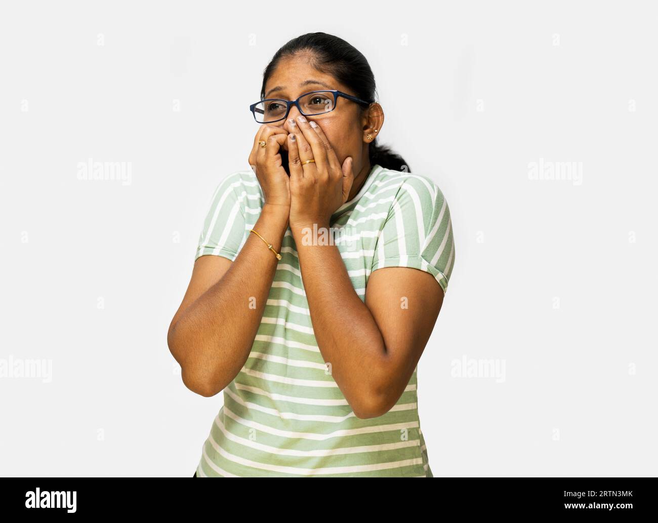 A Woman Afraid And Closing Her Mouth With Both Hands On A White