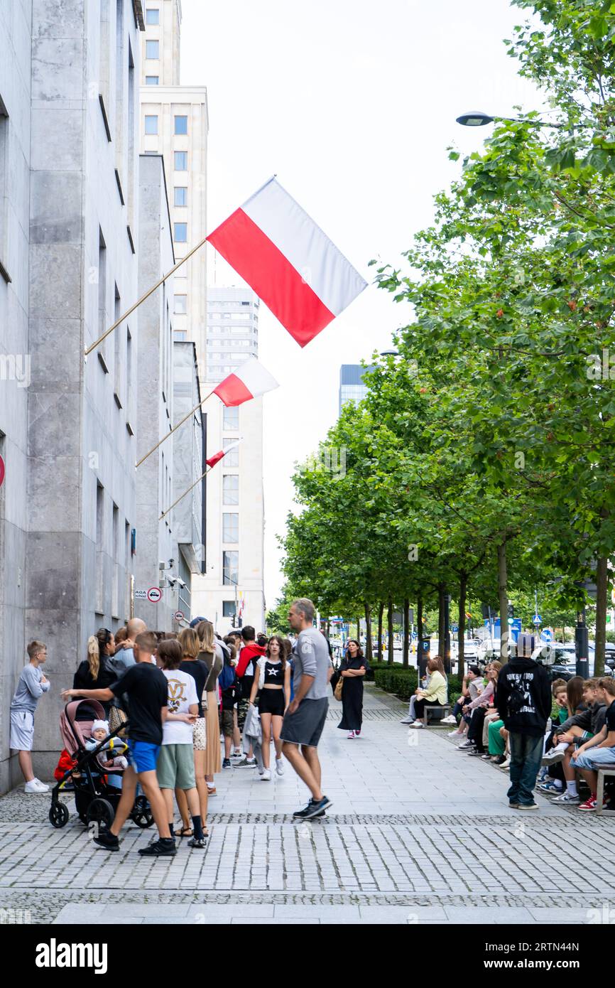 People in line. Flags of Poland on the street. National Polish Bank NBP ...