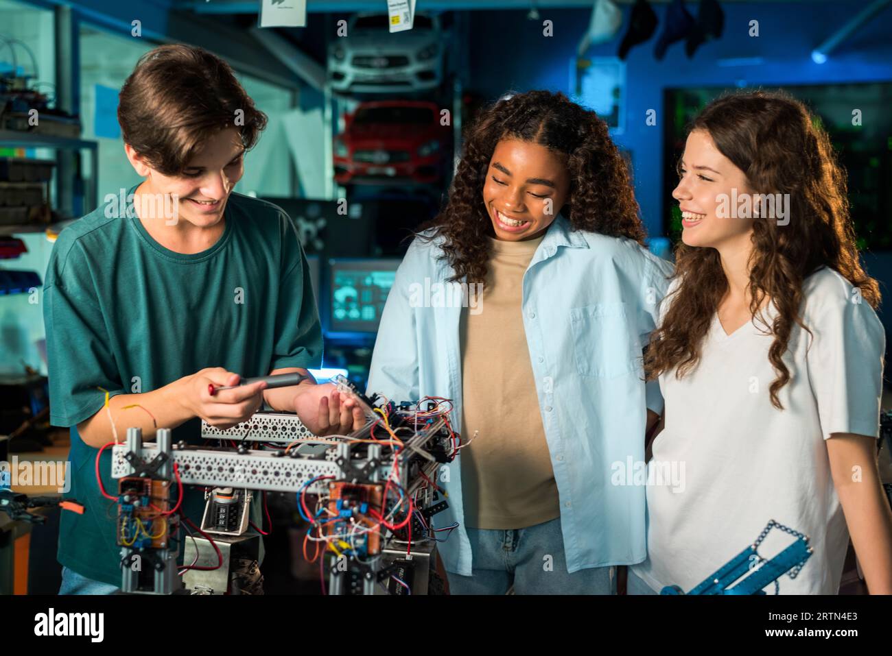 Group of young people doing experiments in robotics in a laboratory ...