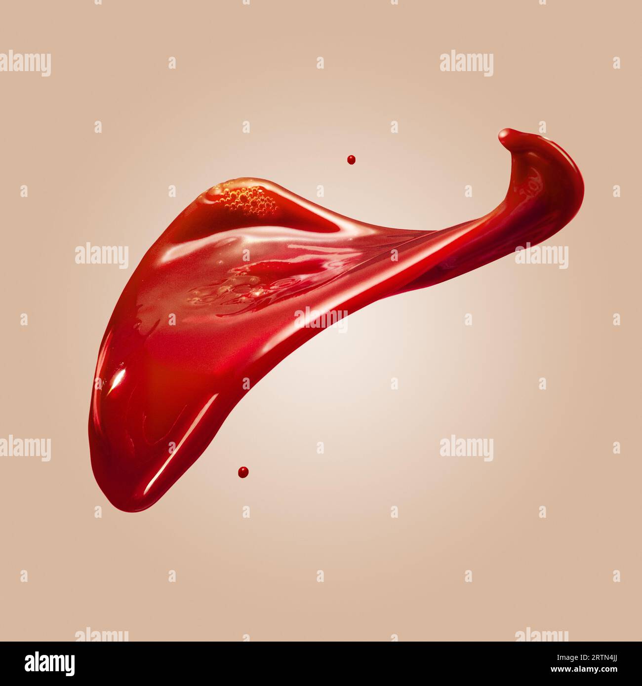 Levitating red splash isolated on brown background. Liquid paint, color ...
