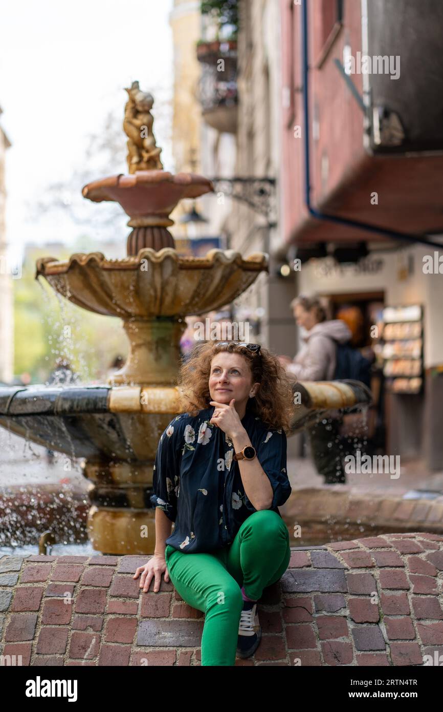 Ginger woman model posing against architecturial elements. Various ...