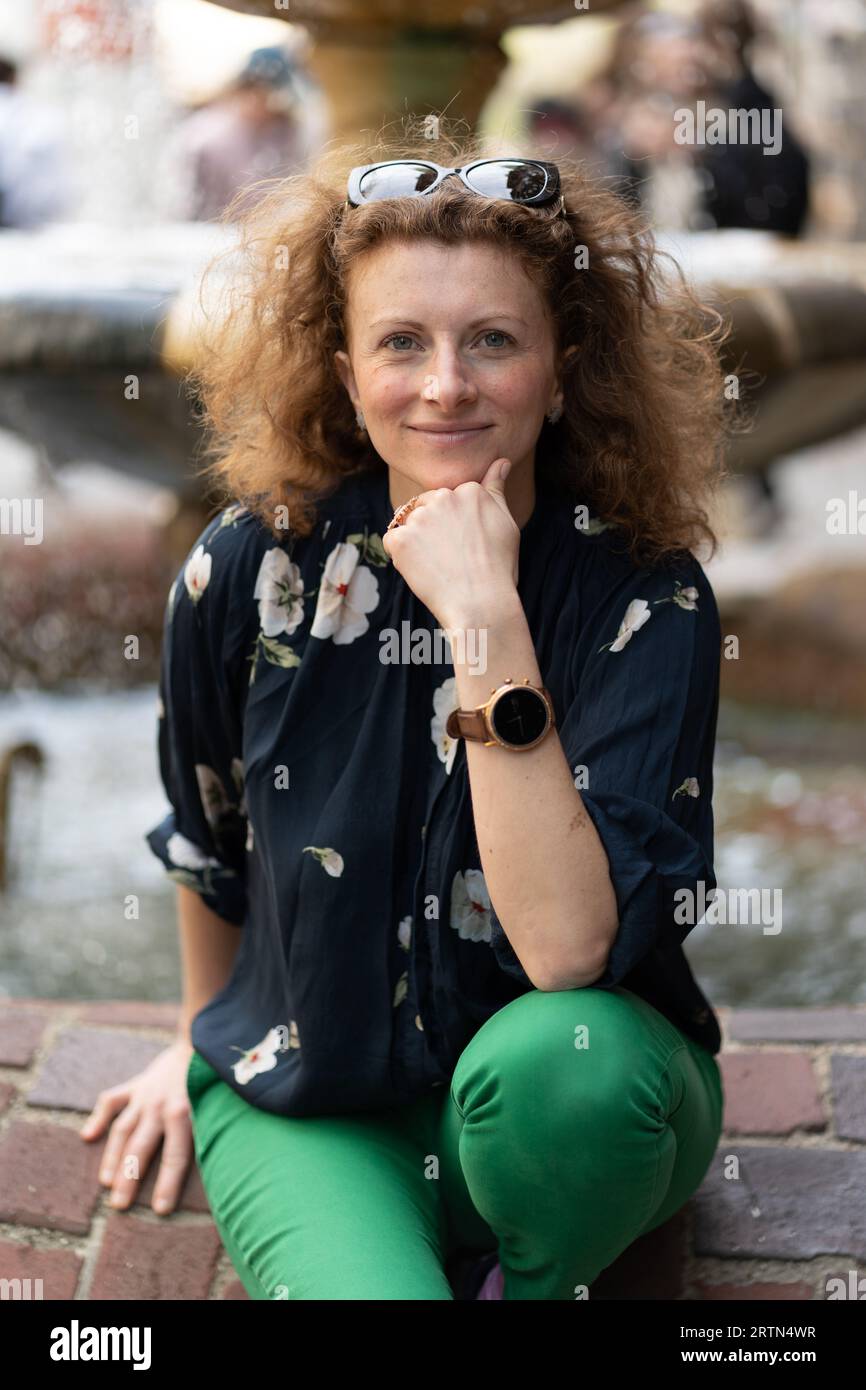 Ginger woman model posing against architecturial elements. Various ...