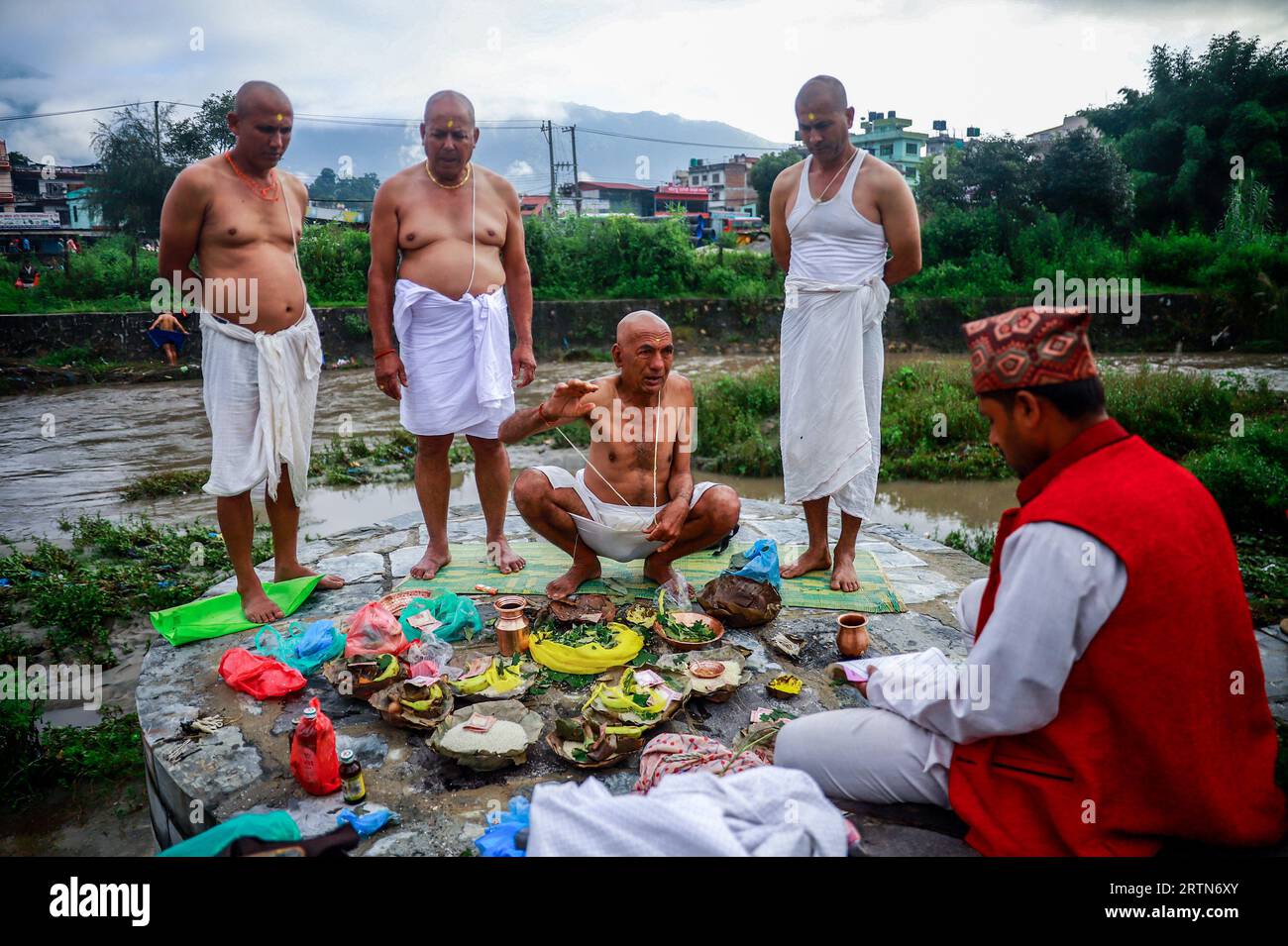 Kathmandu, Nepal. 14th Sep, 2023. A Hindu priest recites prayers from a ...