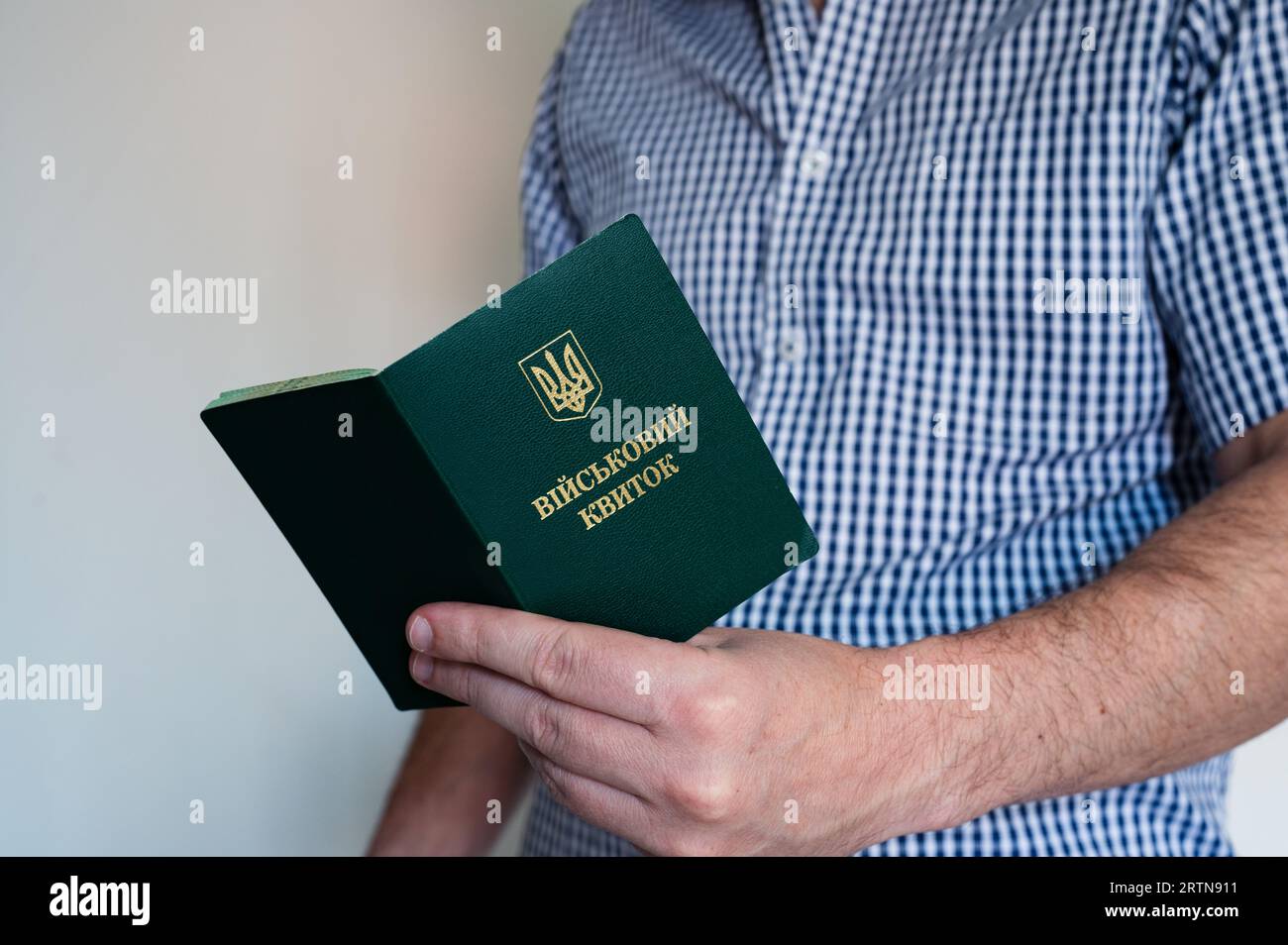 Translation: "military id". Civil man in shirt with open army document ...