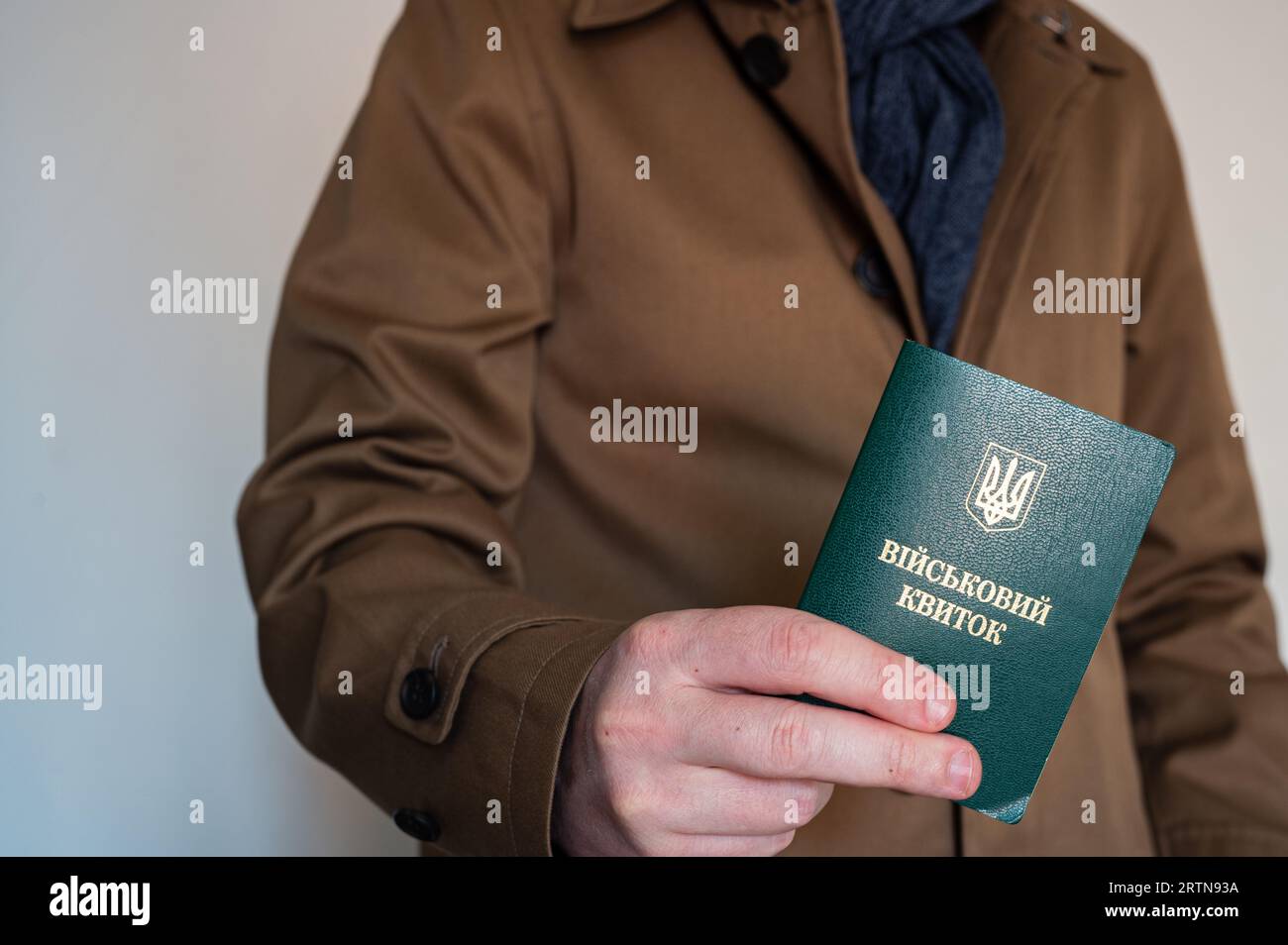 Translation: "military id". Man in coat holds army document for rookie ...
