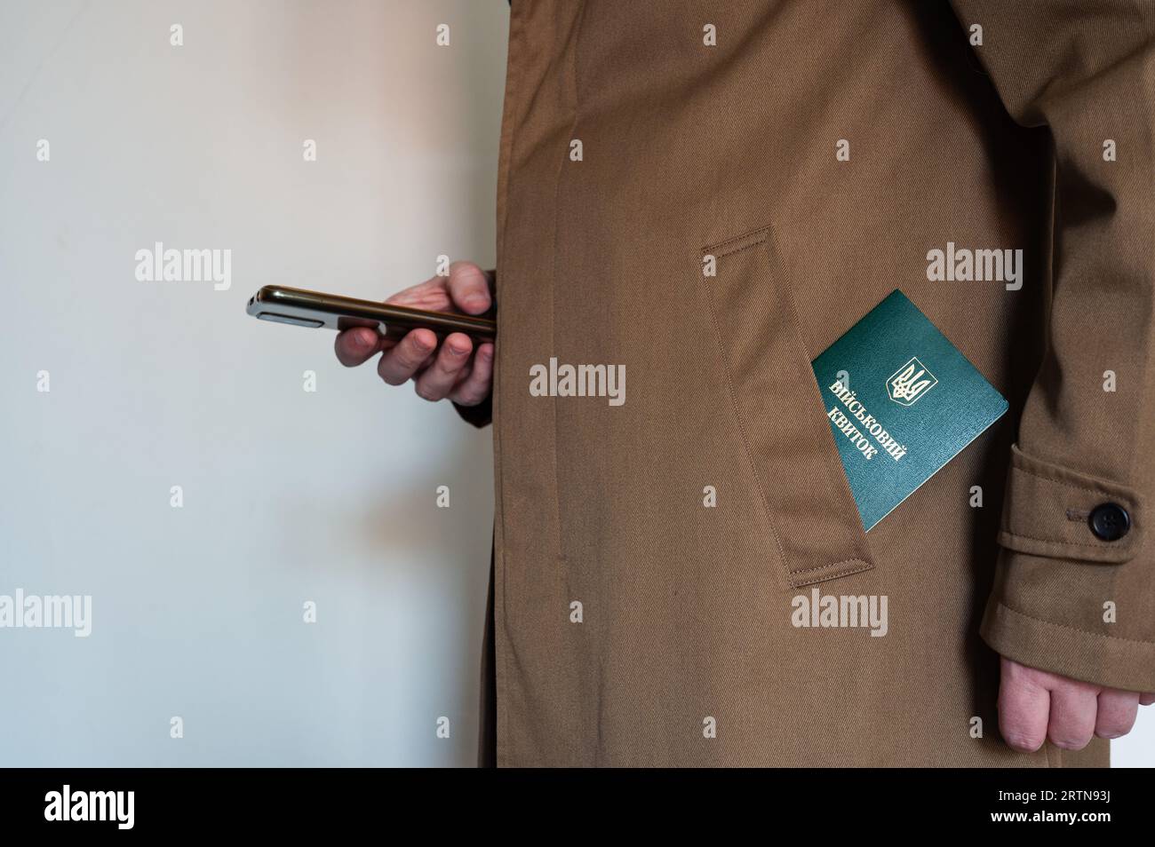 Translation: "military id". Civil man holds smartphone in one hand and ...