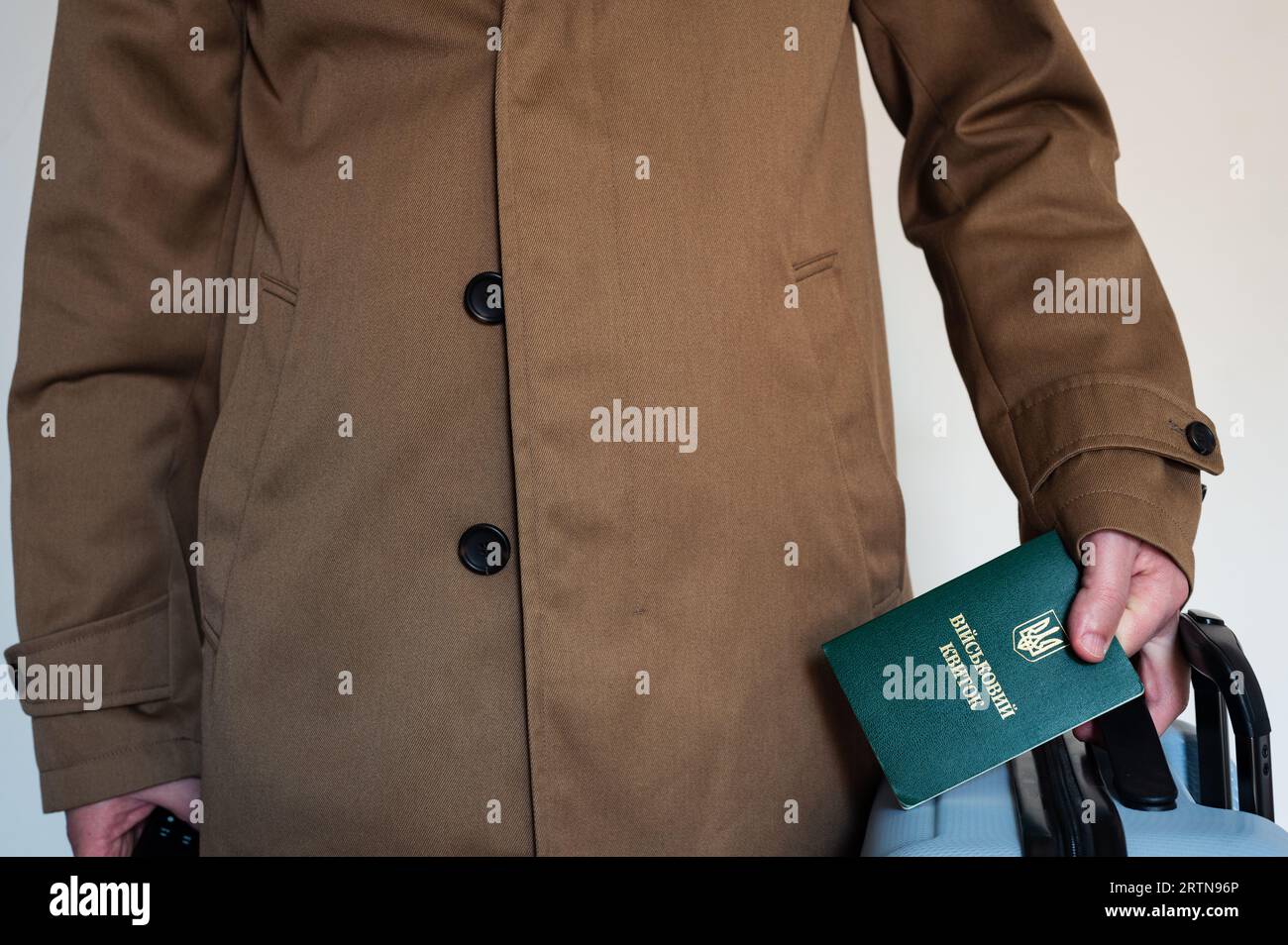 Translation: "military id". Civil man holds travel bag and has ...