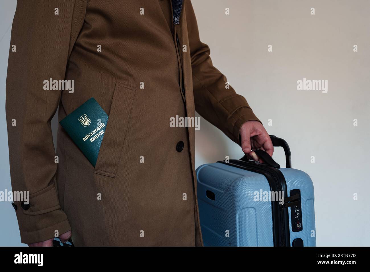 Translation: "military id". Civil man holds travel bag and has ...