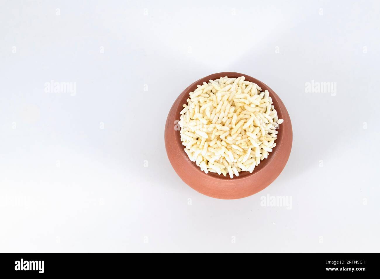 resh rice puff in mud pot and isolated in white background. Called Pori ...