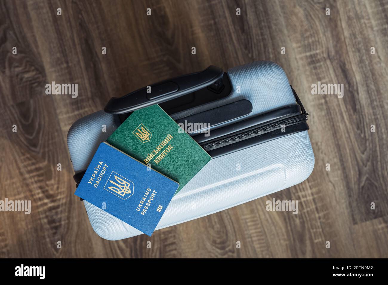 Translation: "military id". Travel blue suitcase stands on wooden floor ...