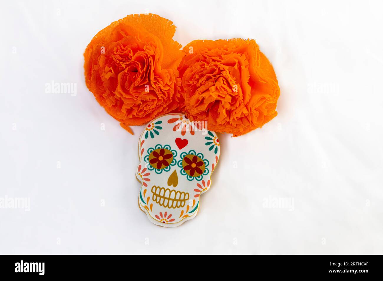 Cookies with shapes of Mexican catrinas and orange marigold flowers to ...
