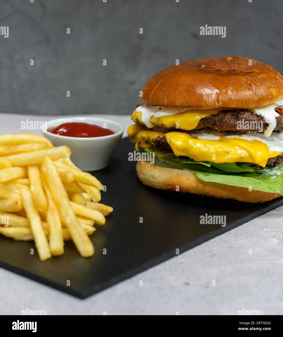 Delicious fast food burgers, MEGA Burger fries ketchup Stock Photo - Alamy