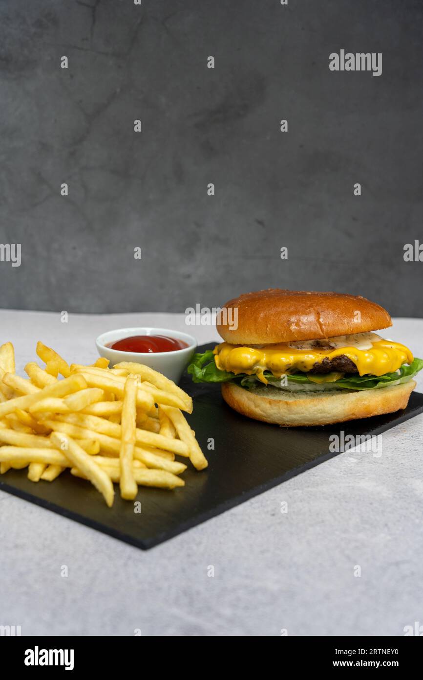 Delicious fast food burgers, MEGA Burger fries ketchup Stock Photo - Alamy