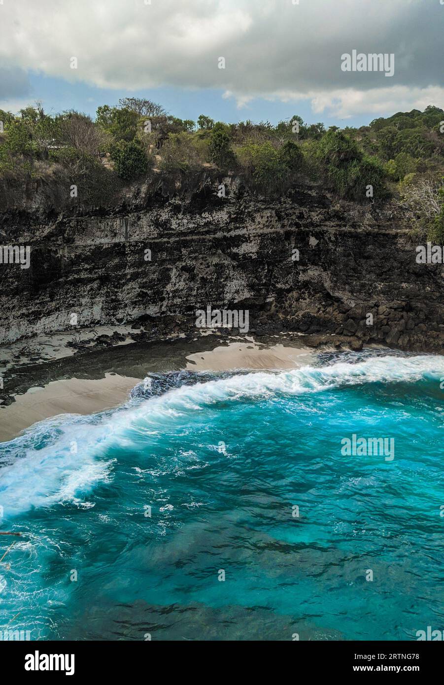 Majestic towering cliffs surround a serene turquoise bay at Broken ...