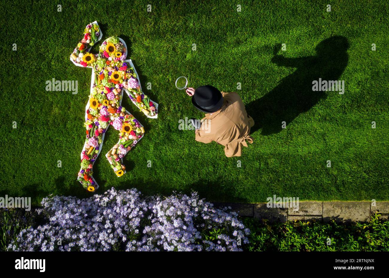 Alexander McDonnell, playing the role of a detective, views a floral ...