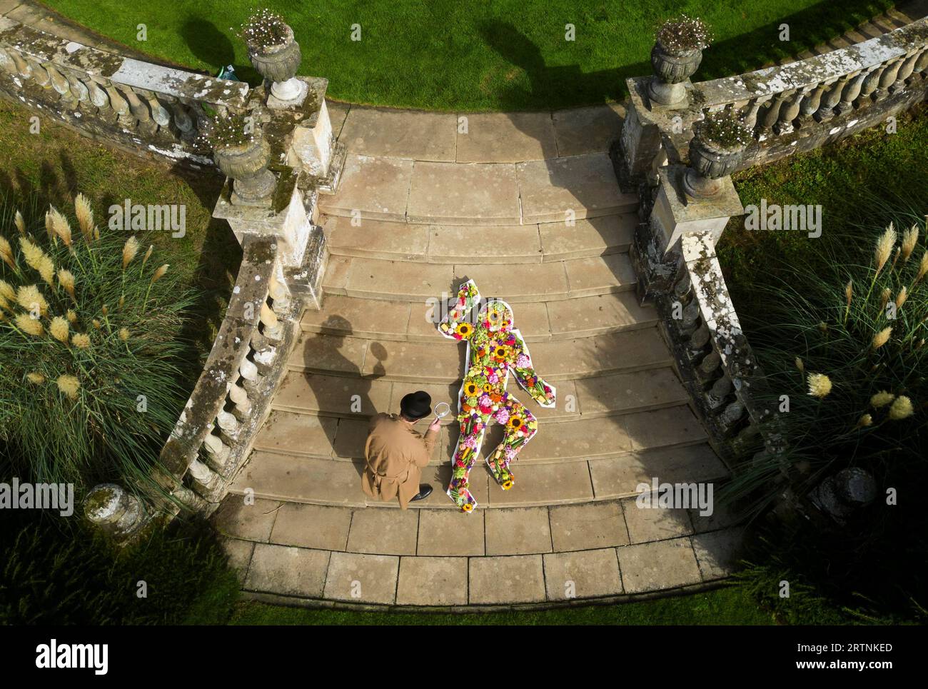 Alexander McDonnell, playing the role of a detective, views a floral ...